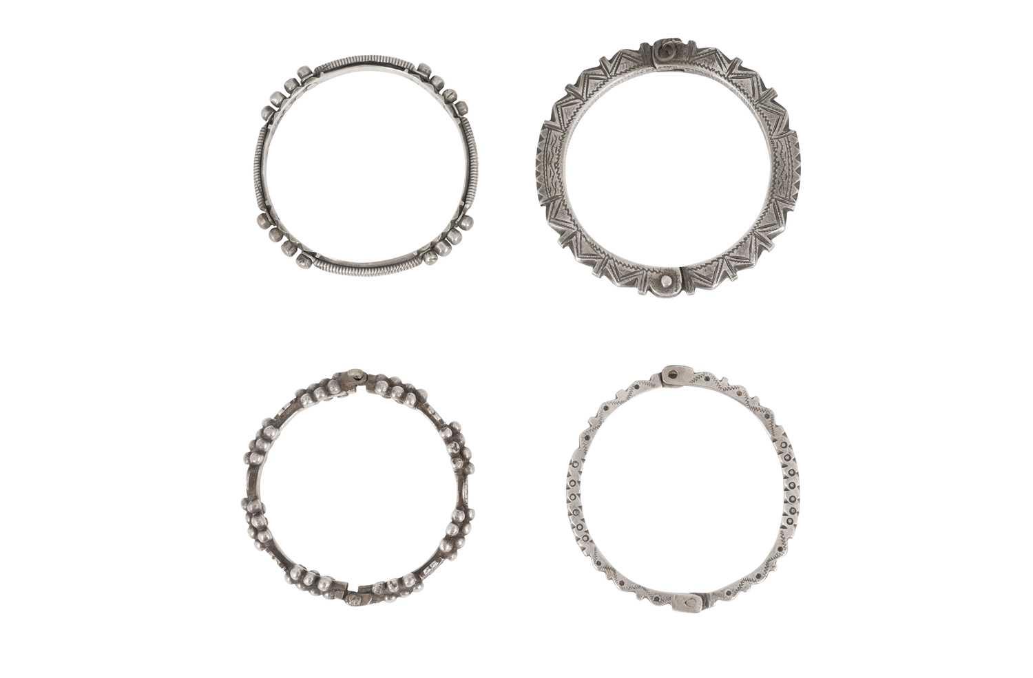 Lot 23 - FOUR SAHARAN SILVER BANGLES